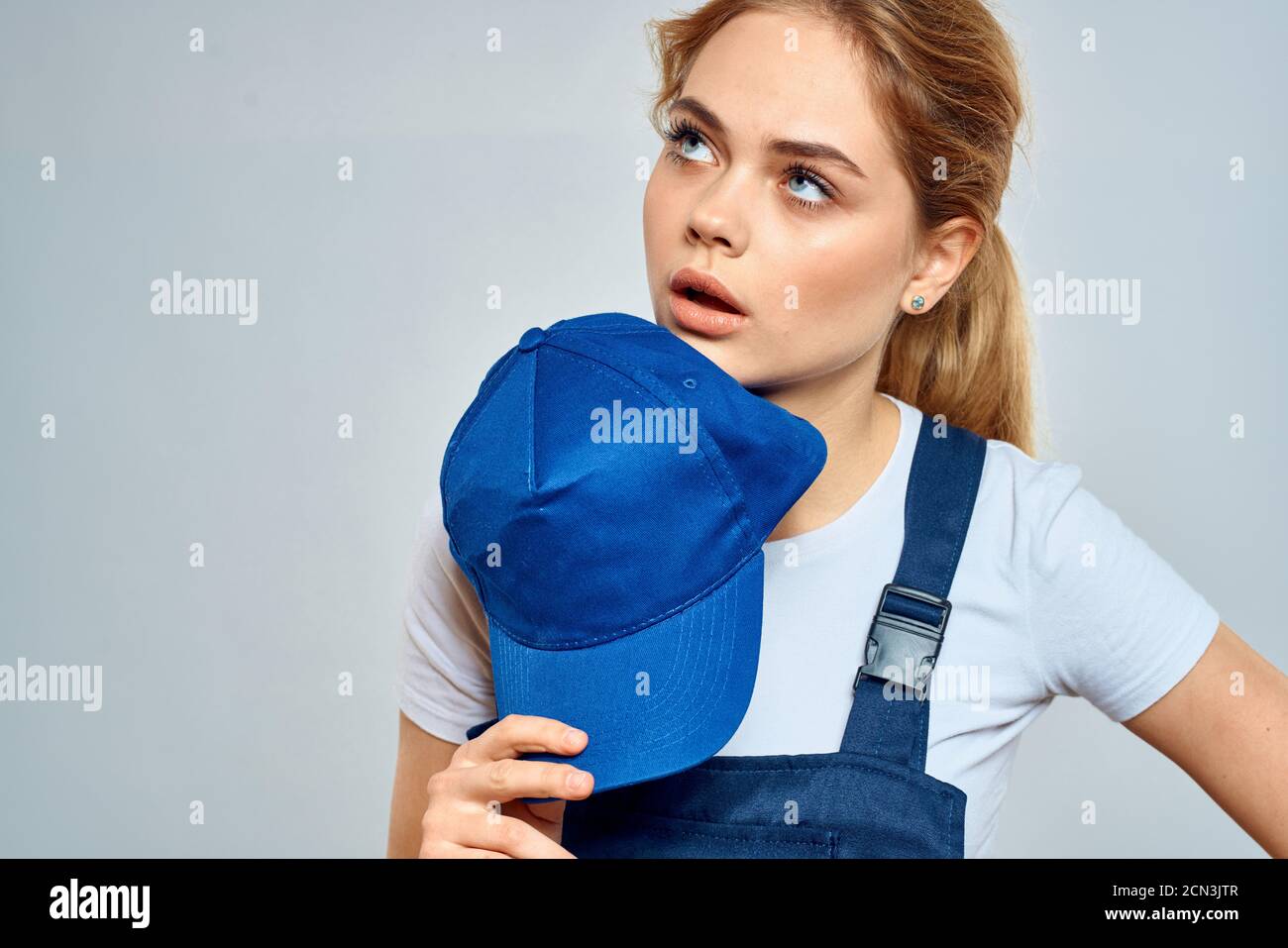 woman in work uniform blue cap service delivery service light ...