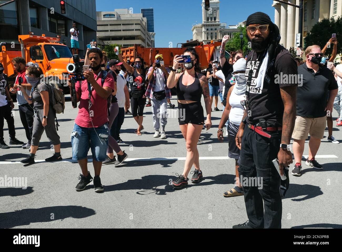Protesters, some armed, stand by as armed militia groups leave the ...