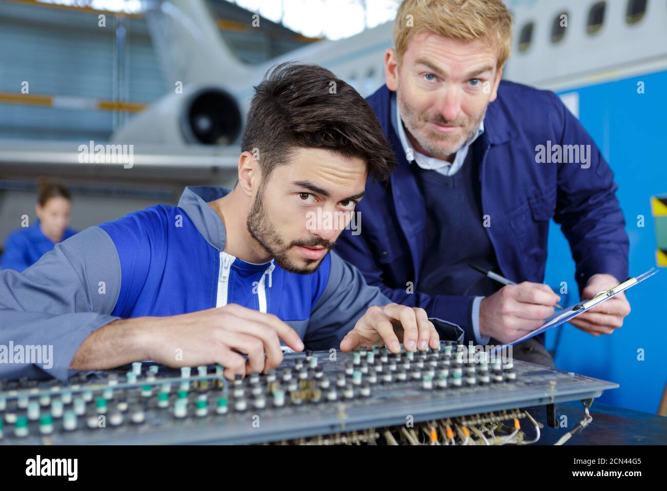 handyman measuring part of airplane motor Stock Photo - Alamy