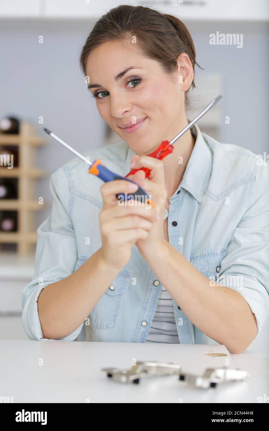 smiling young woman showing her work tool Stock Photo - Alamy
