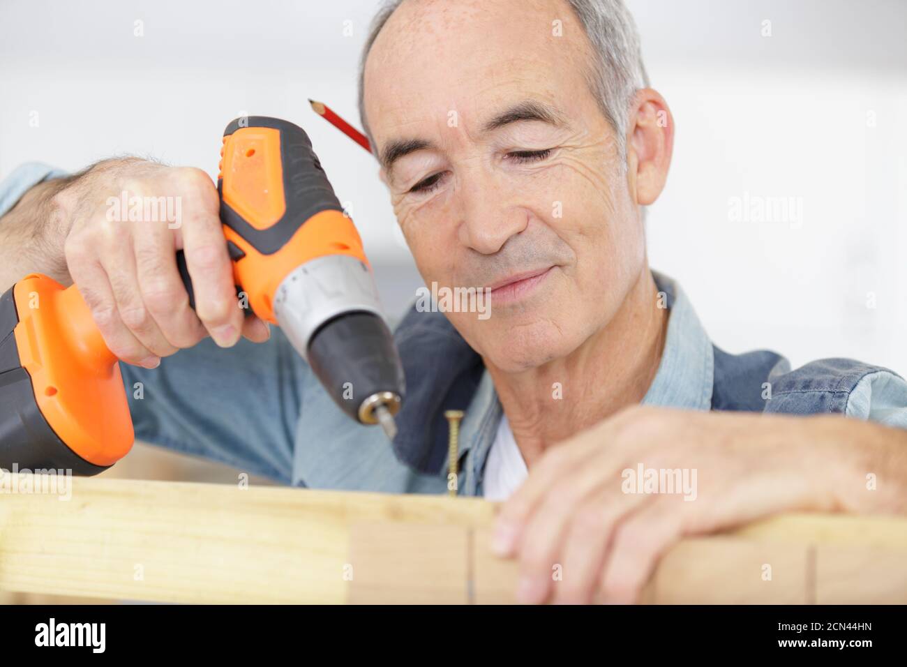 Worker using screwdriver on furniture hi-res stock photography and ...