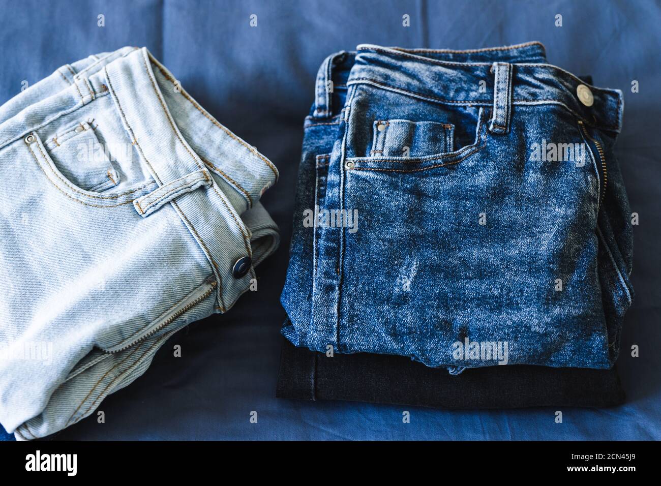 tidying up and organizing your wardrobe, different jeans in various ...