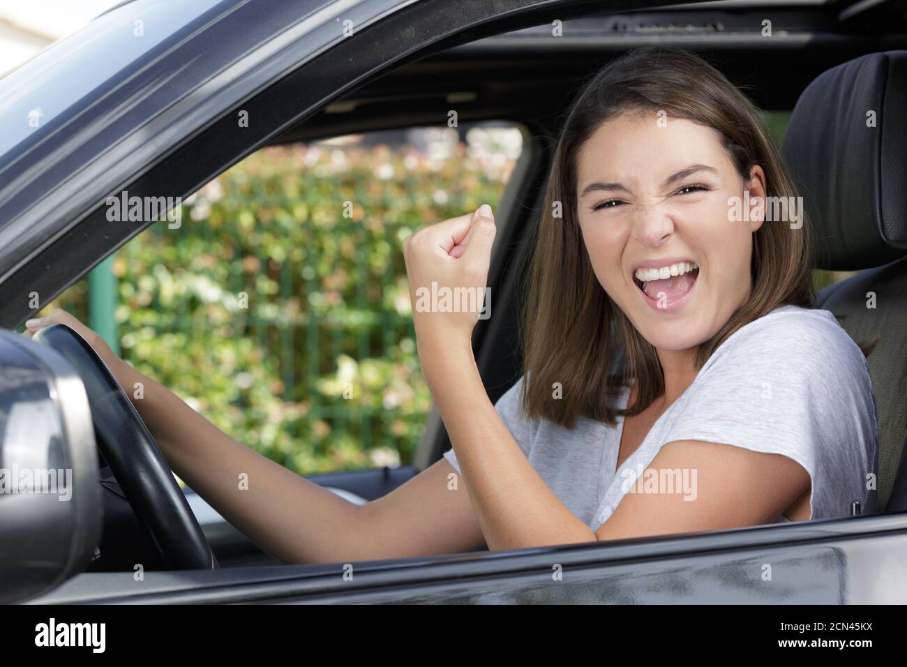 happy woman driving a new car positive face expression Stock Photo - Alamy