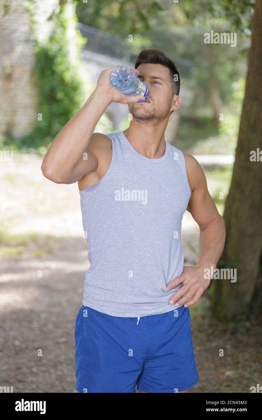 Muscular men drinking water from hi-res stock photography and images ...