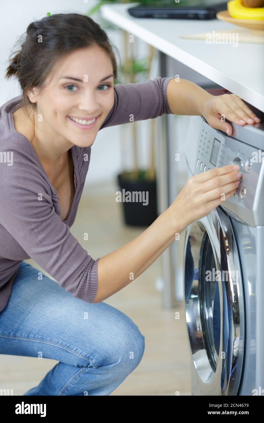 loading clothes into washing machine Stock Photo - Alamy