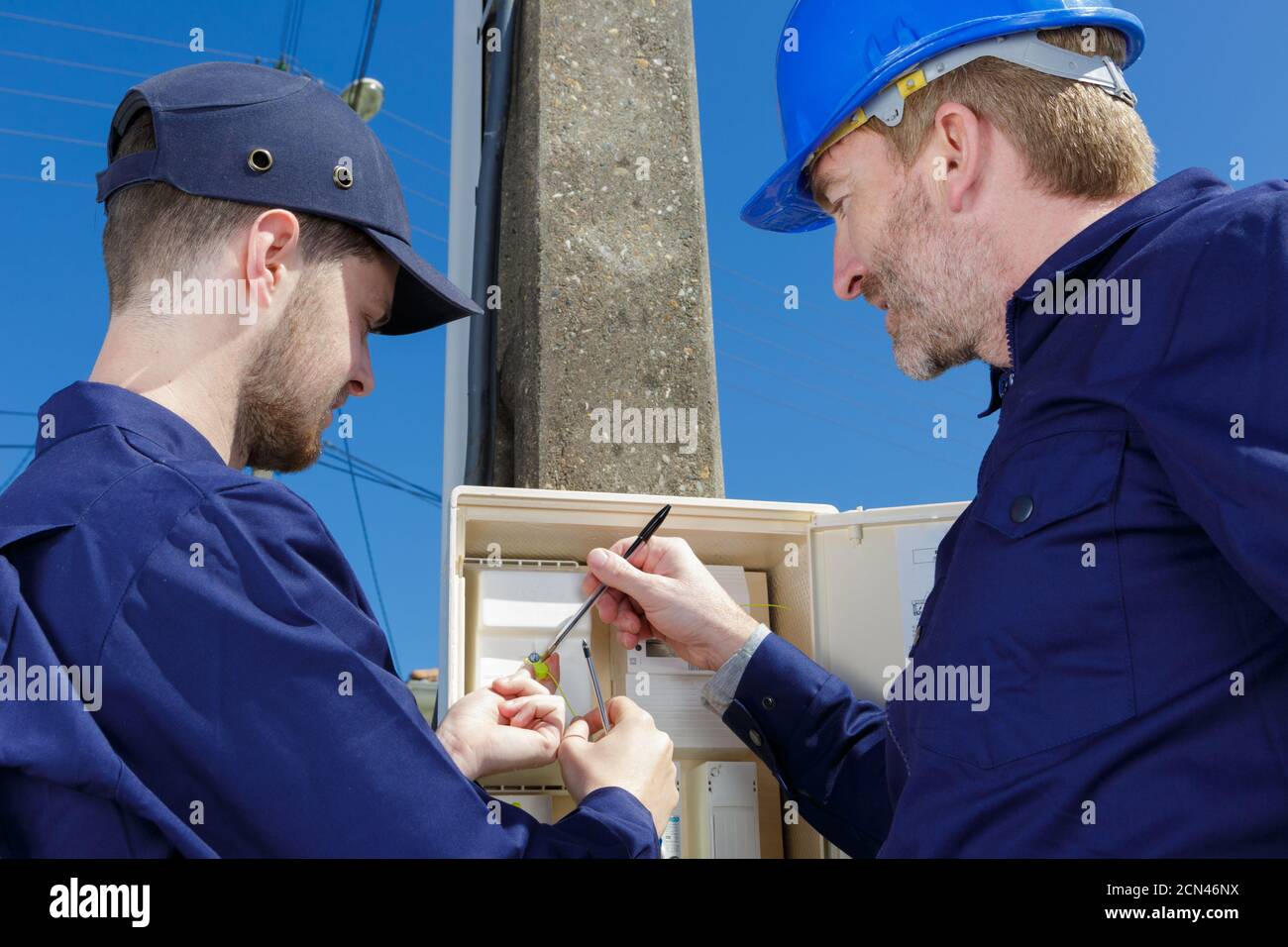 electrical apprentice together with the teacher Stock Photo - Alamy