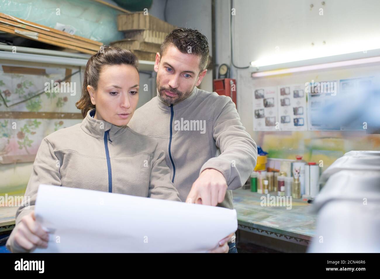 man and woman are checking drawing on the working site Stock Photo - Alamy
