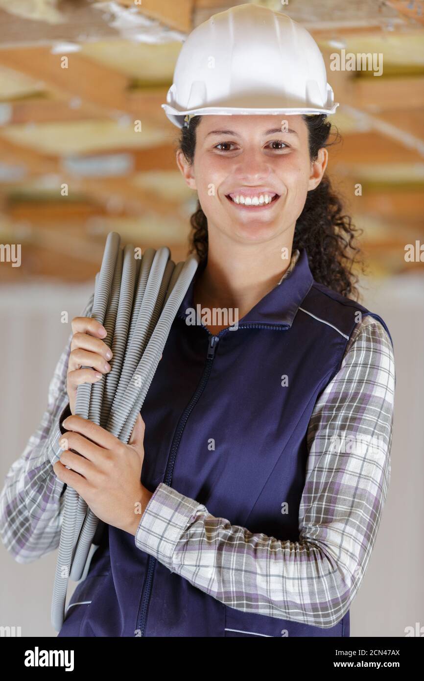 portrait of female worker cable reel over her shoulder Stock Photo - Alamy