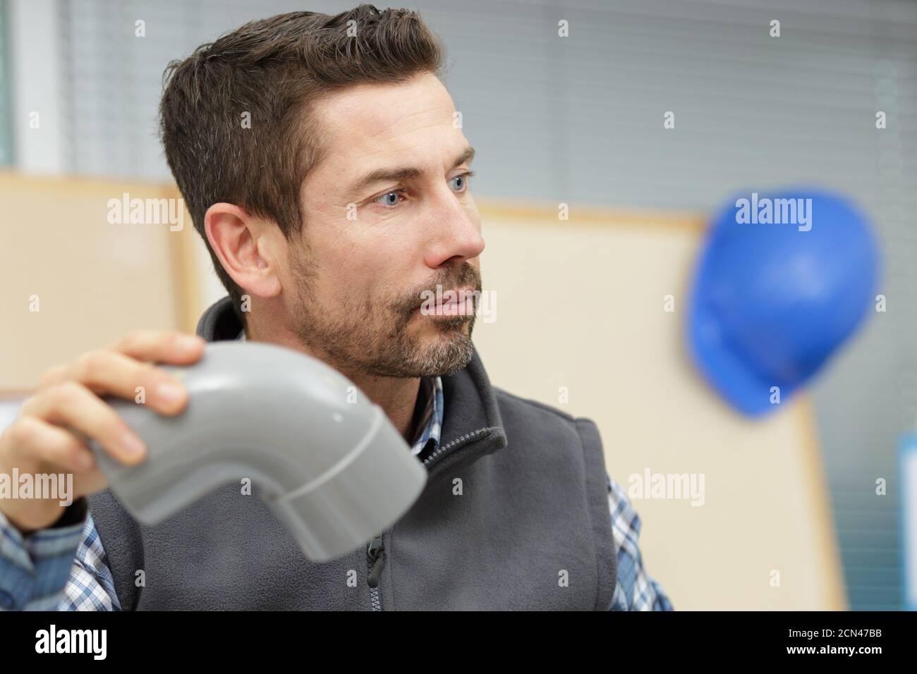 a man during installation of pipes Stock Photo - Alamy