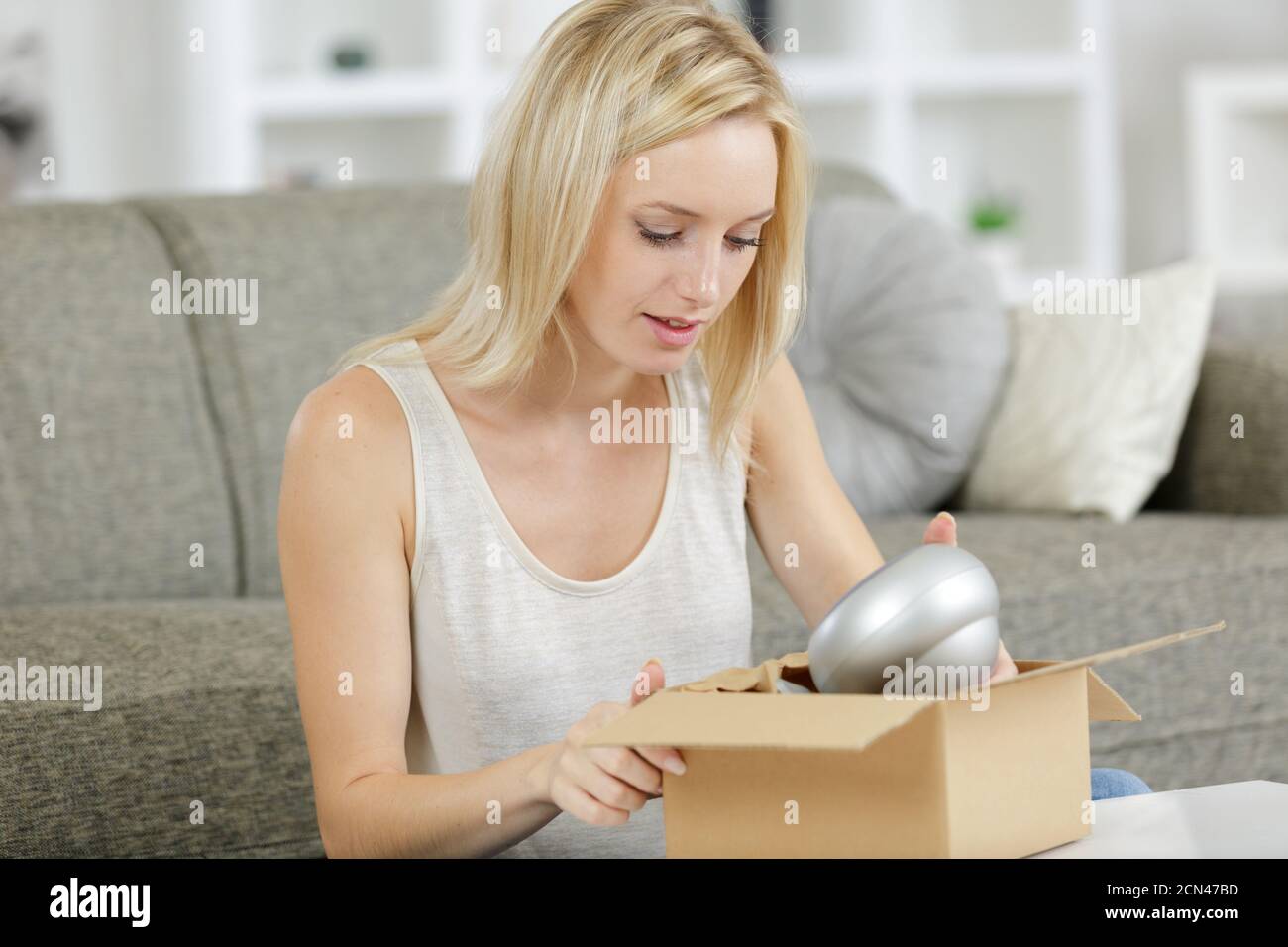 Surprise woman unpacking carton box hi-res stock photography and images ...