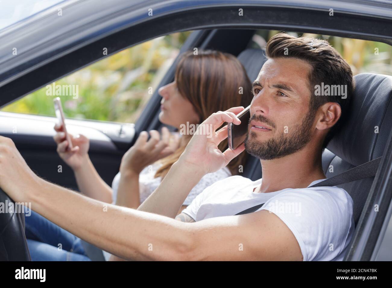 driver and co-pilot using a mobile phone in a car Stock Photo - Alamy