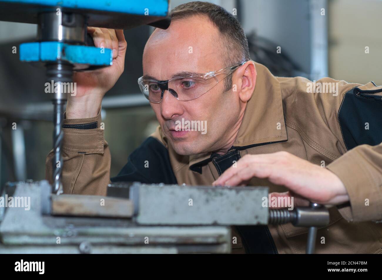 portrait of master drilling machine Stock Photo - Alamy