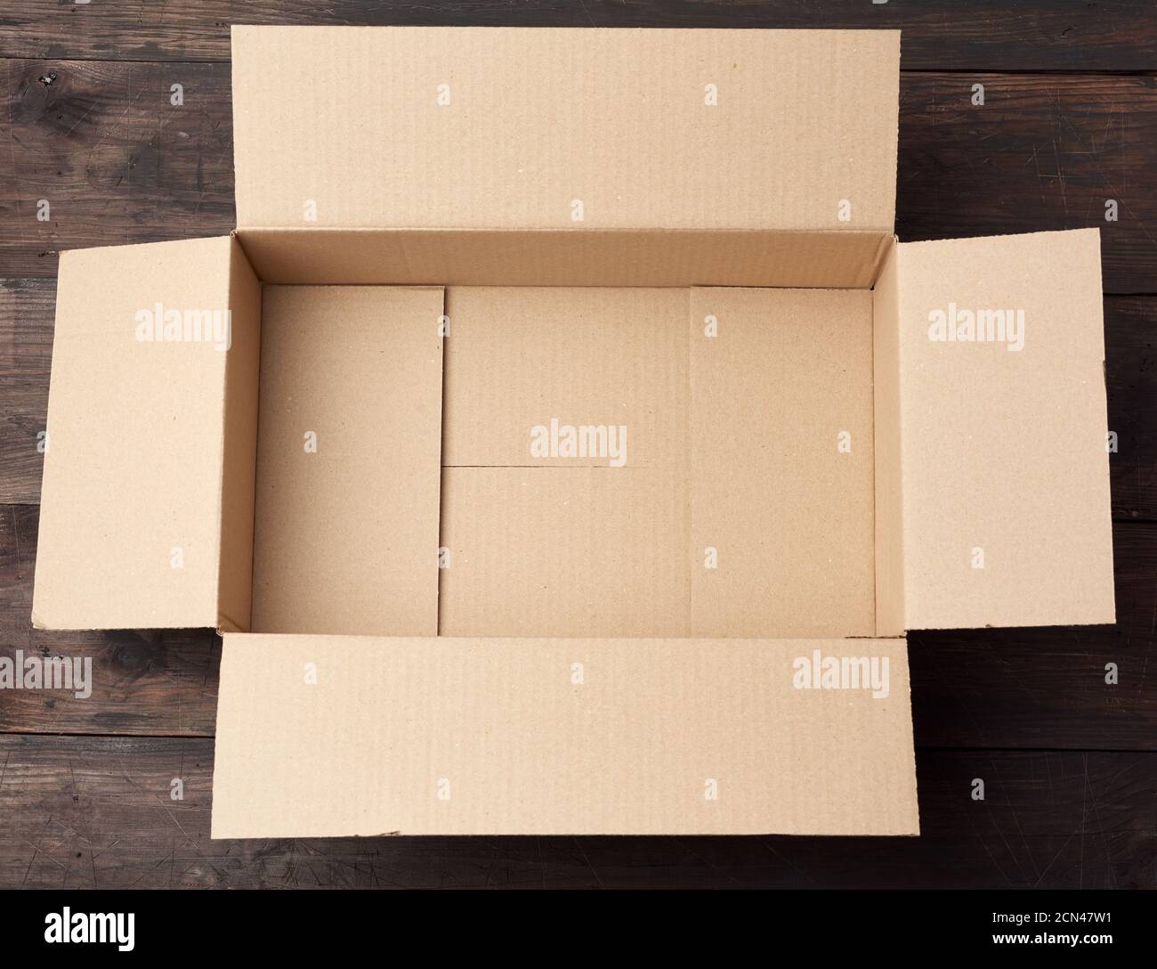 open brown square cardboard box for transporting goods Stock Photo - Alamy
