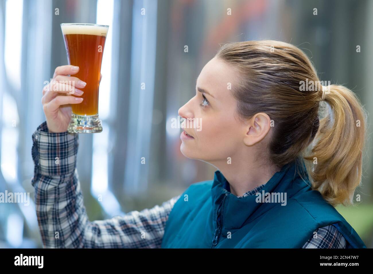 woman tasting beer Stock Photo - Alamy