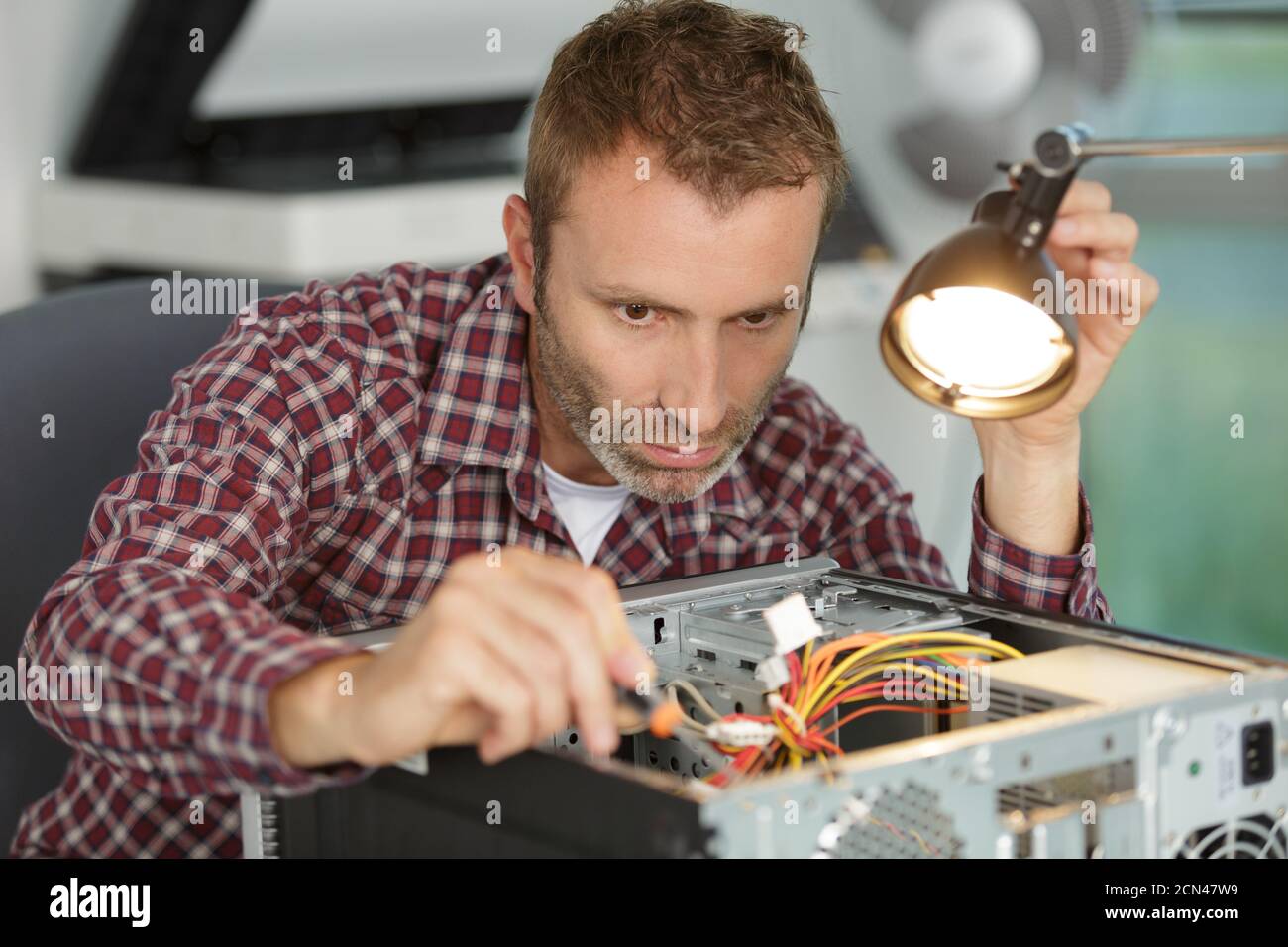 a man fixing the electronics Stock Photo - Alamy
