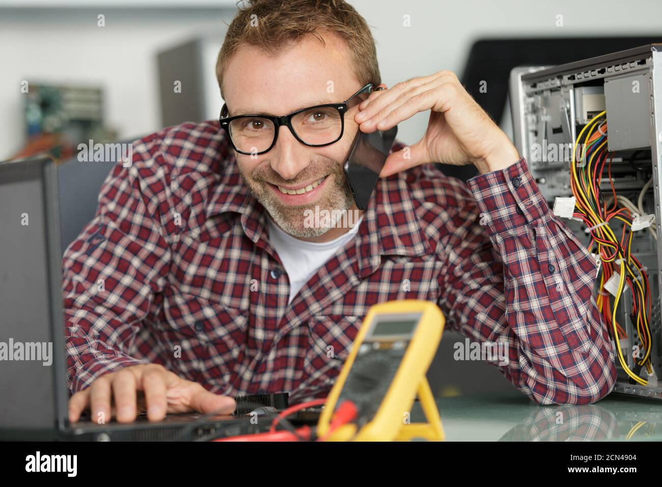 happy computer engineer repairing broken desktop Stock Photo - Alamy