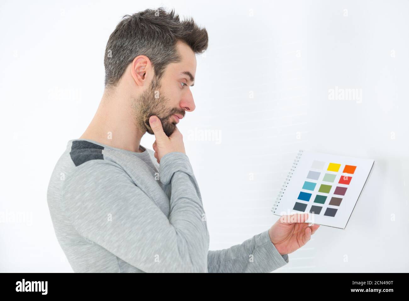 man choosing colour for painting a room Stock Photo - Alamy