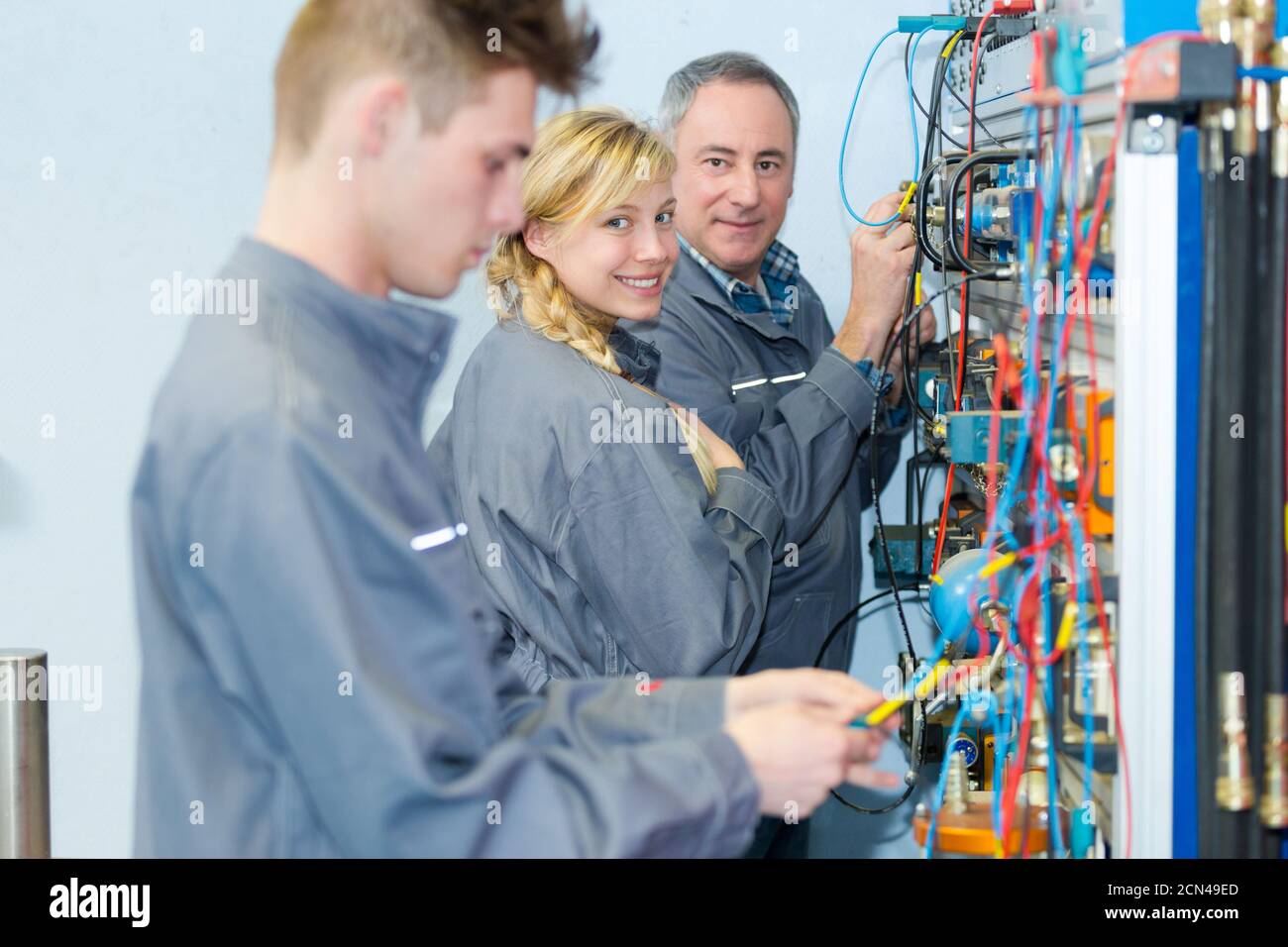electrical technical team staring at colleague Stock Photo - Alamy