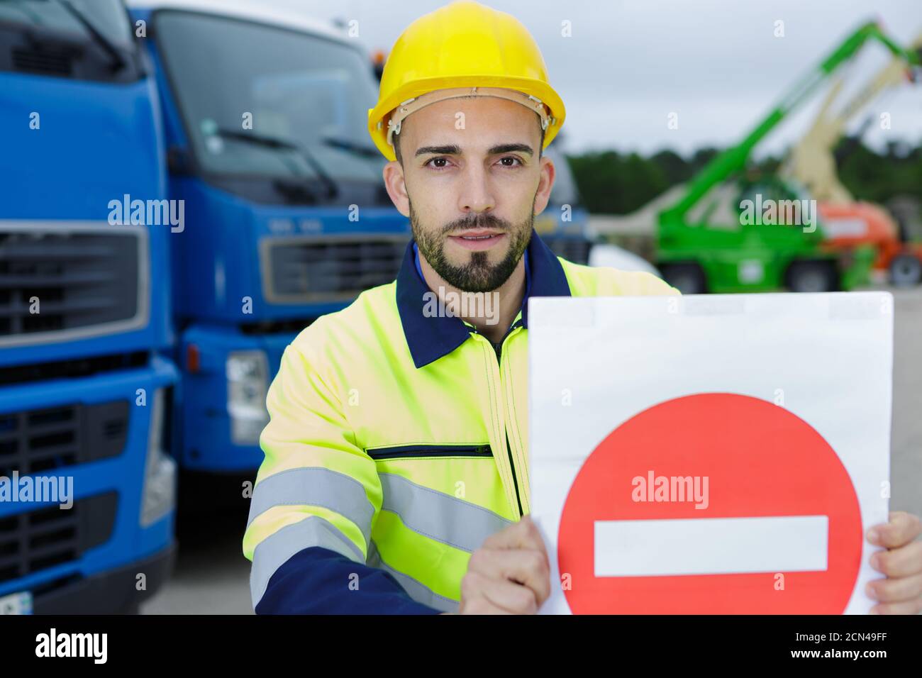 man in reflective clothing holding a no entry sign Stock Photo - Alamy