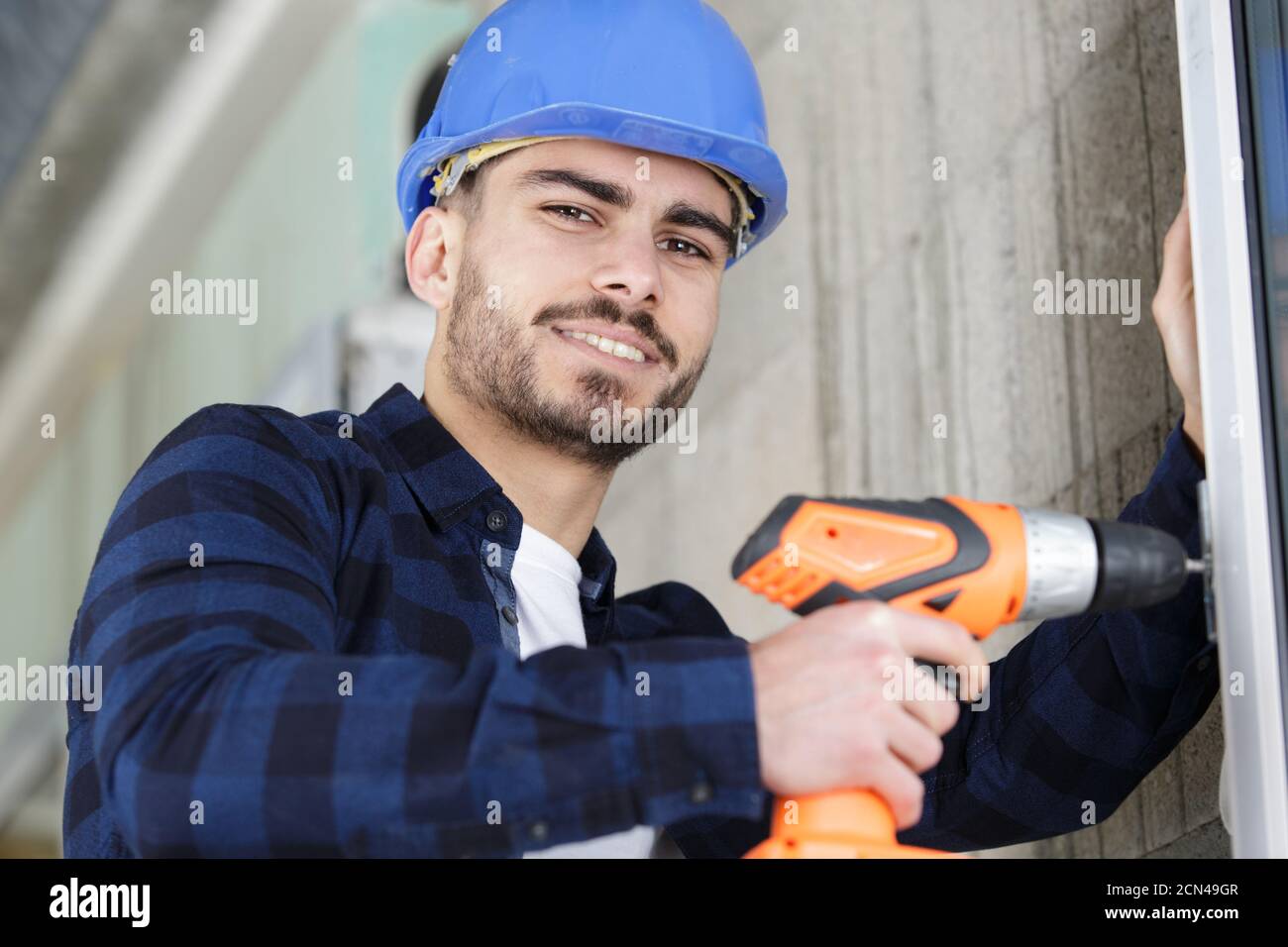 Young man using drill machine hi-res stock photography and images - Alamy