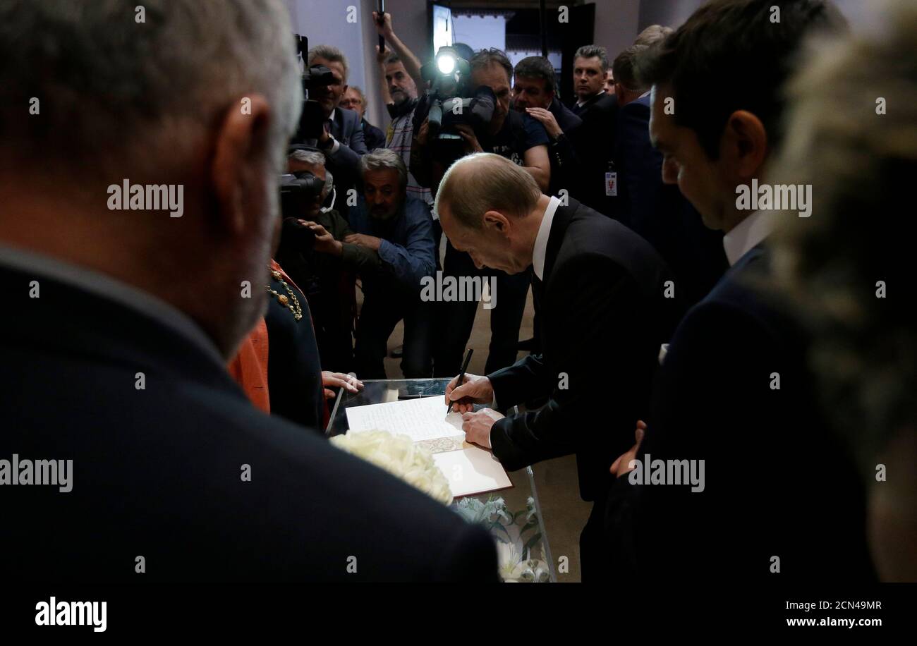 Russian President Vladimir Putin signs a book at the Byzantine and ...