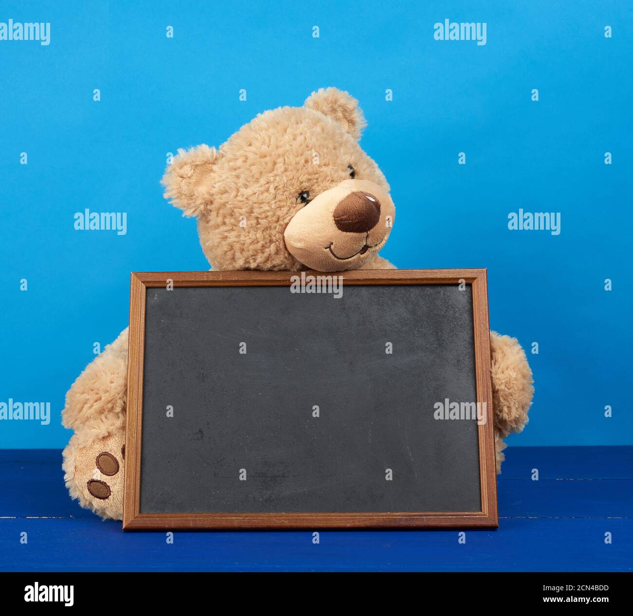 brown teddy bear and empty wooden rectangular frame Stock Photo - Alamy