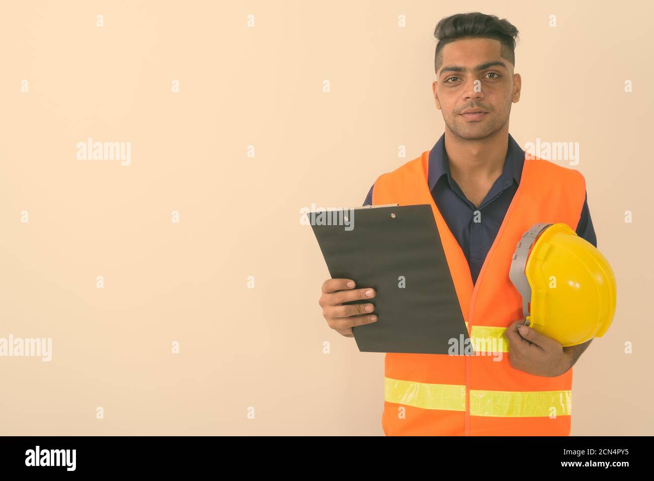 Young Indian man construction worker against white background Stock ...