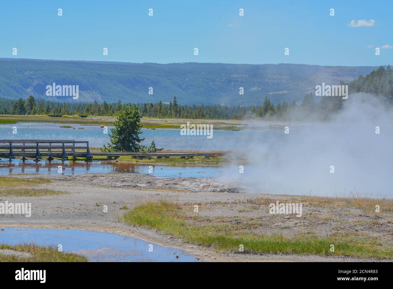 A walkway to view a hot springs with boiling water at the Lower Geyser ...