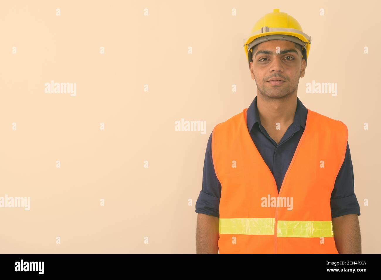 Young Indian man construction worker against white background Stock ...