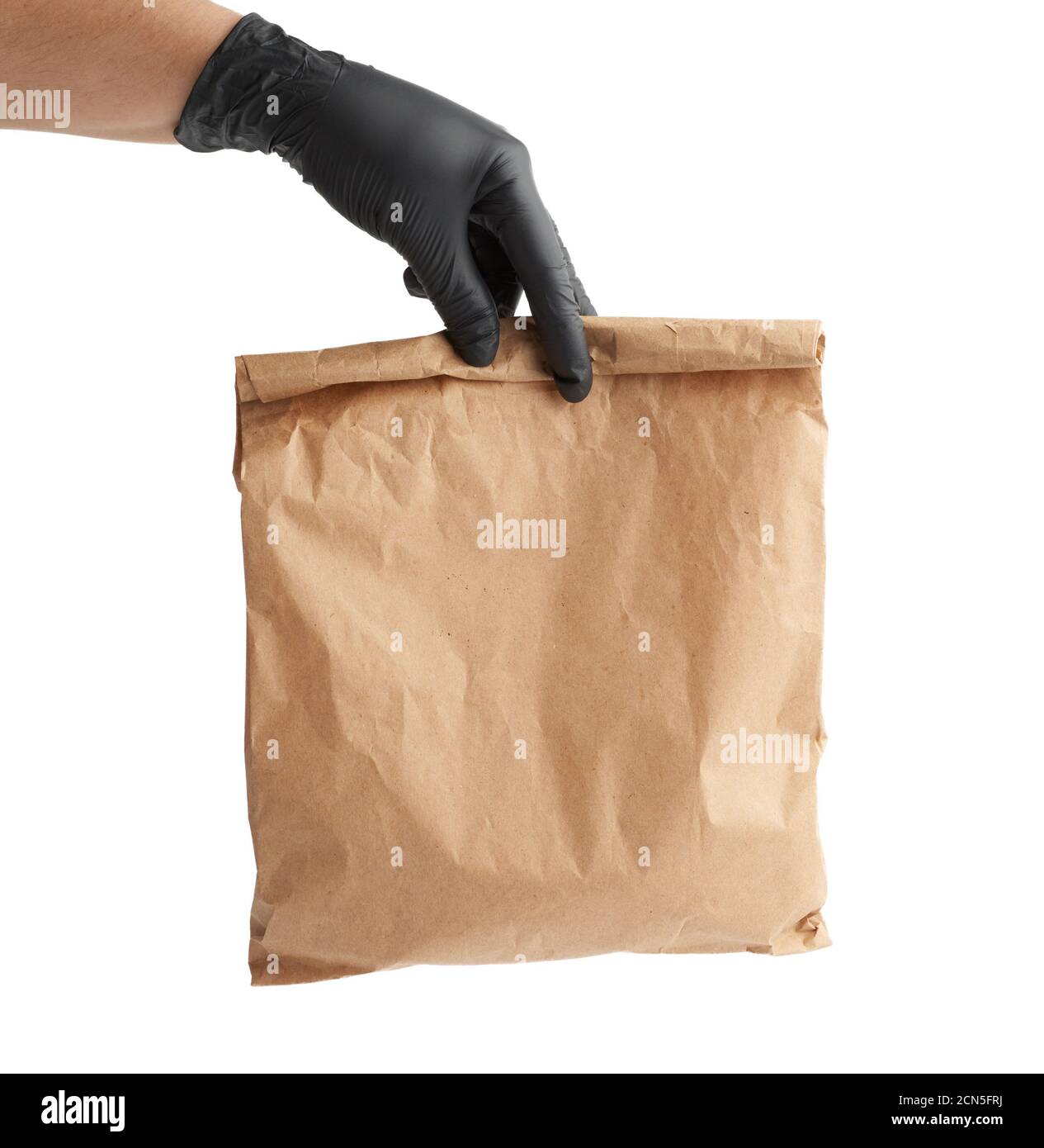 hand in a black latex glove holds a full paper bag of brown craft paper ...