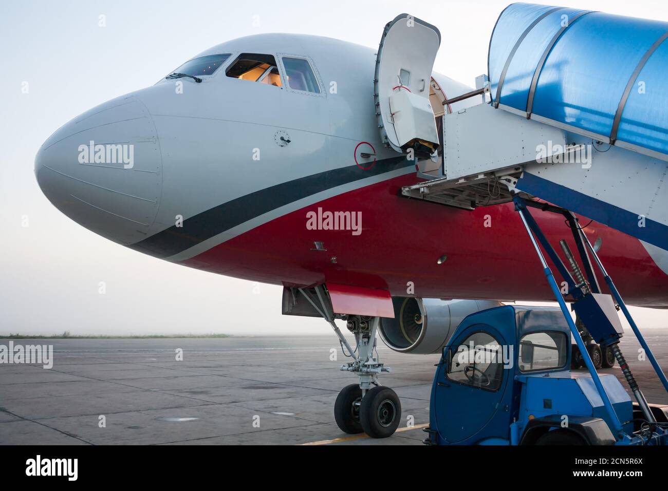 Front of the plane with open door and jetway ramp near Stock Photo - Alamy
