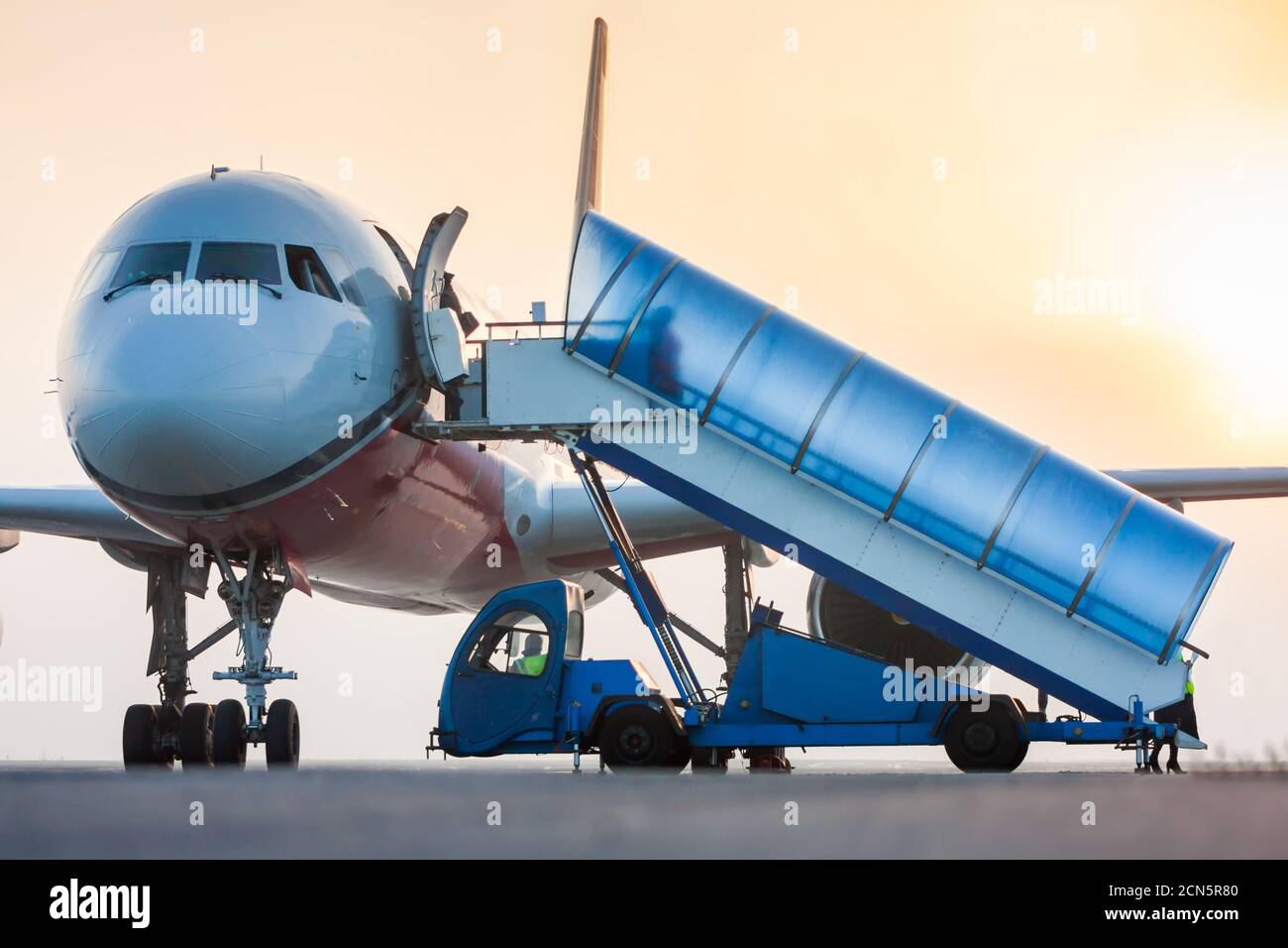 Boarding a plane early misty morning Stock Photo - Alamy