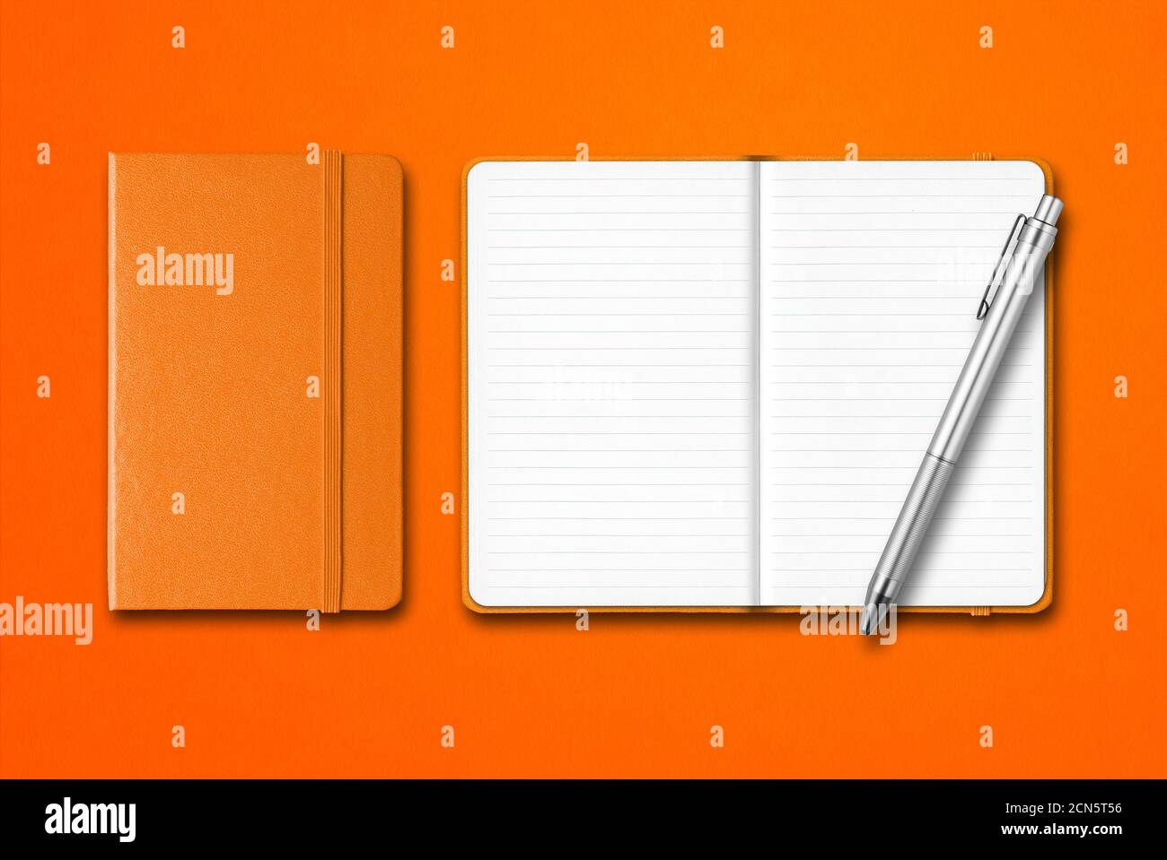 Orange closed and open notebooks with a pen isolated on colorful ...