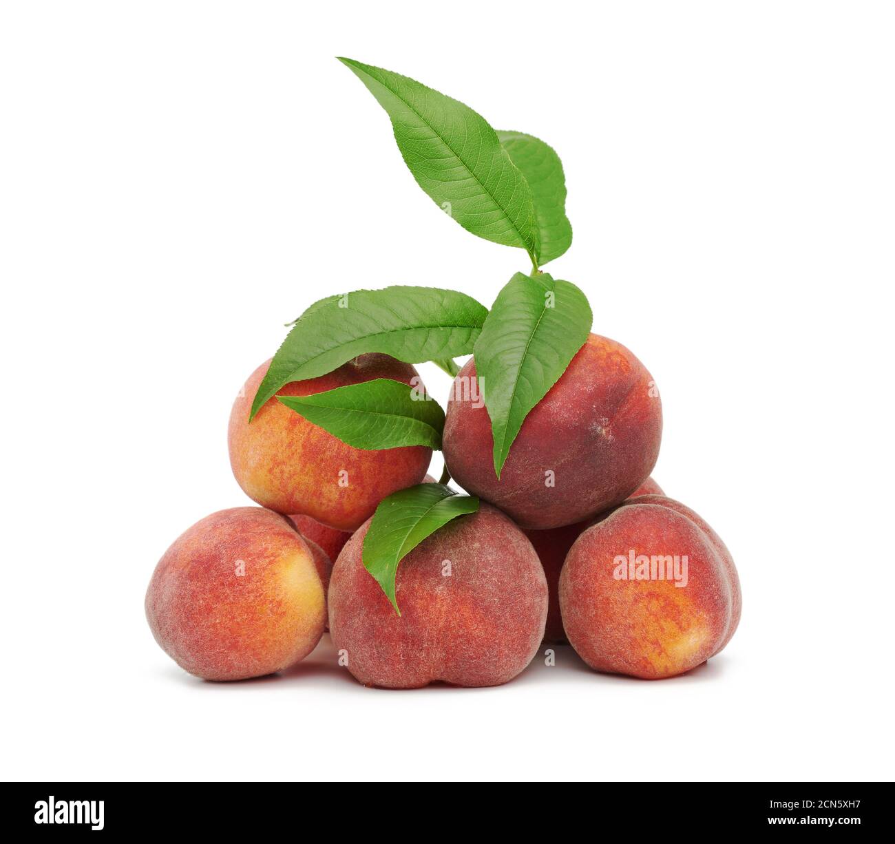 heap of ripe red peach and green leaves, sweet fruit Stock Photo - Alamy