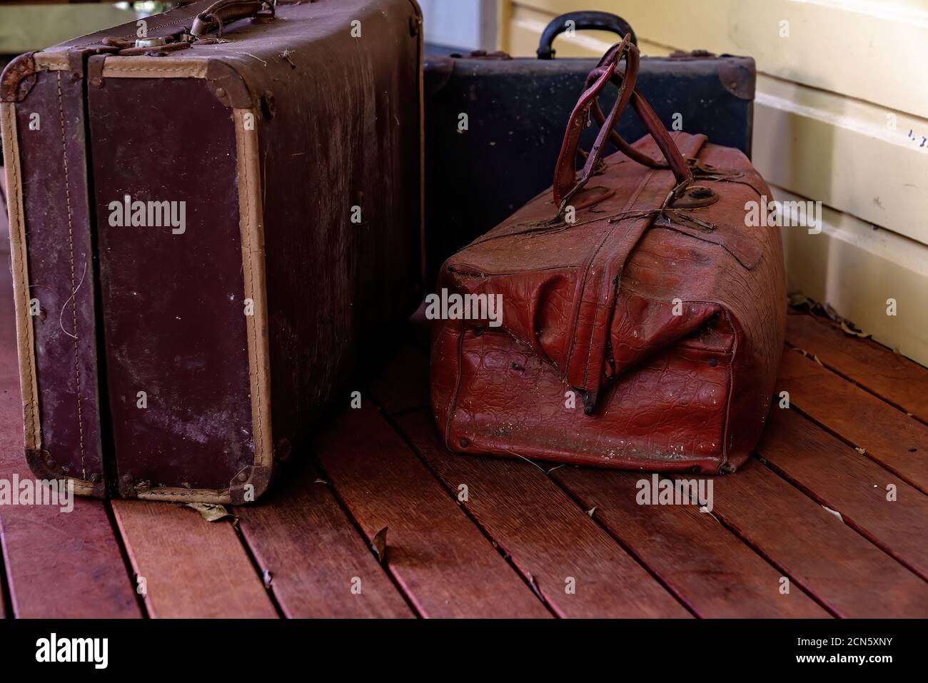 Vintage luggage abandoned on a timber deck to rot and ruin Stock Photo ...