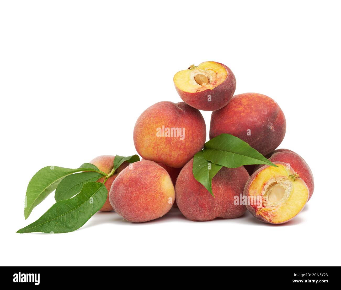 heap of ripe red peach and green leaves, sweet fruit Stock Photo - Alamy