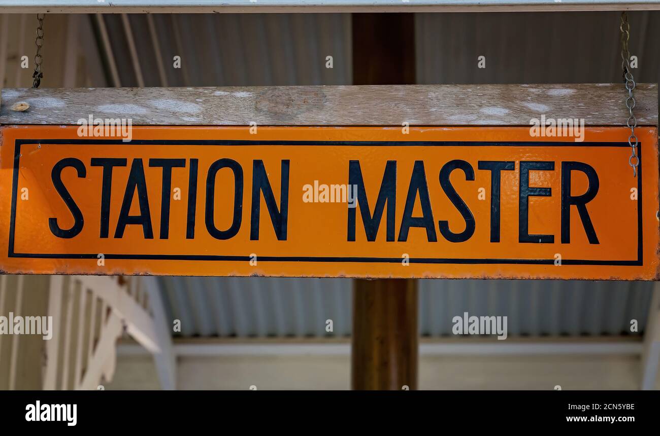 Station Master sign hanging by a chain from a timber board Stock Photo ...