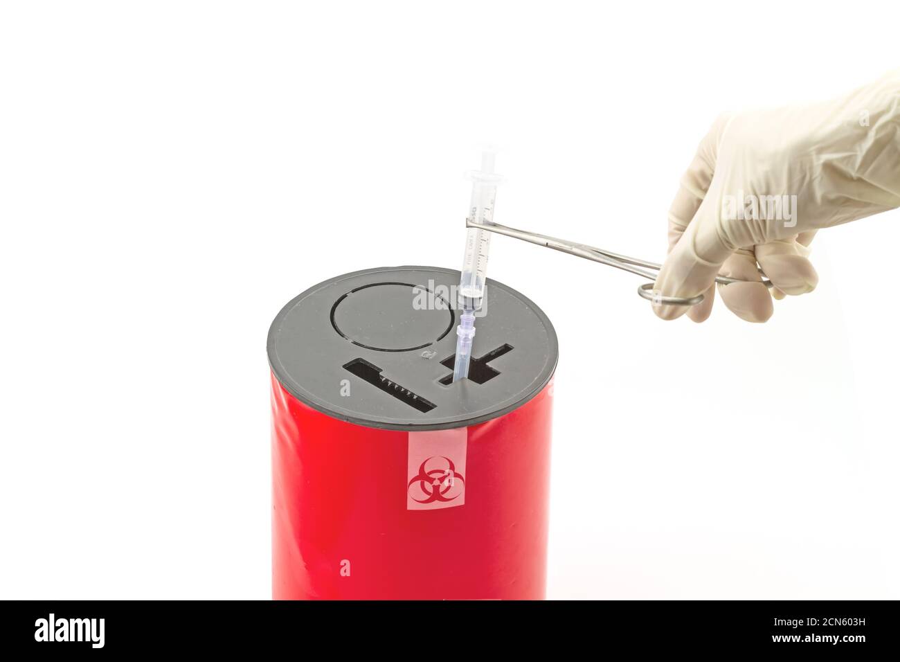 Doctor put syringe in red disposal boxes on white background Stock ...