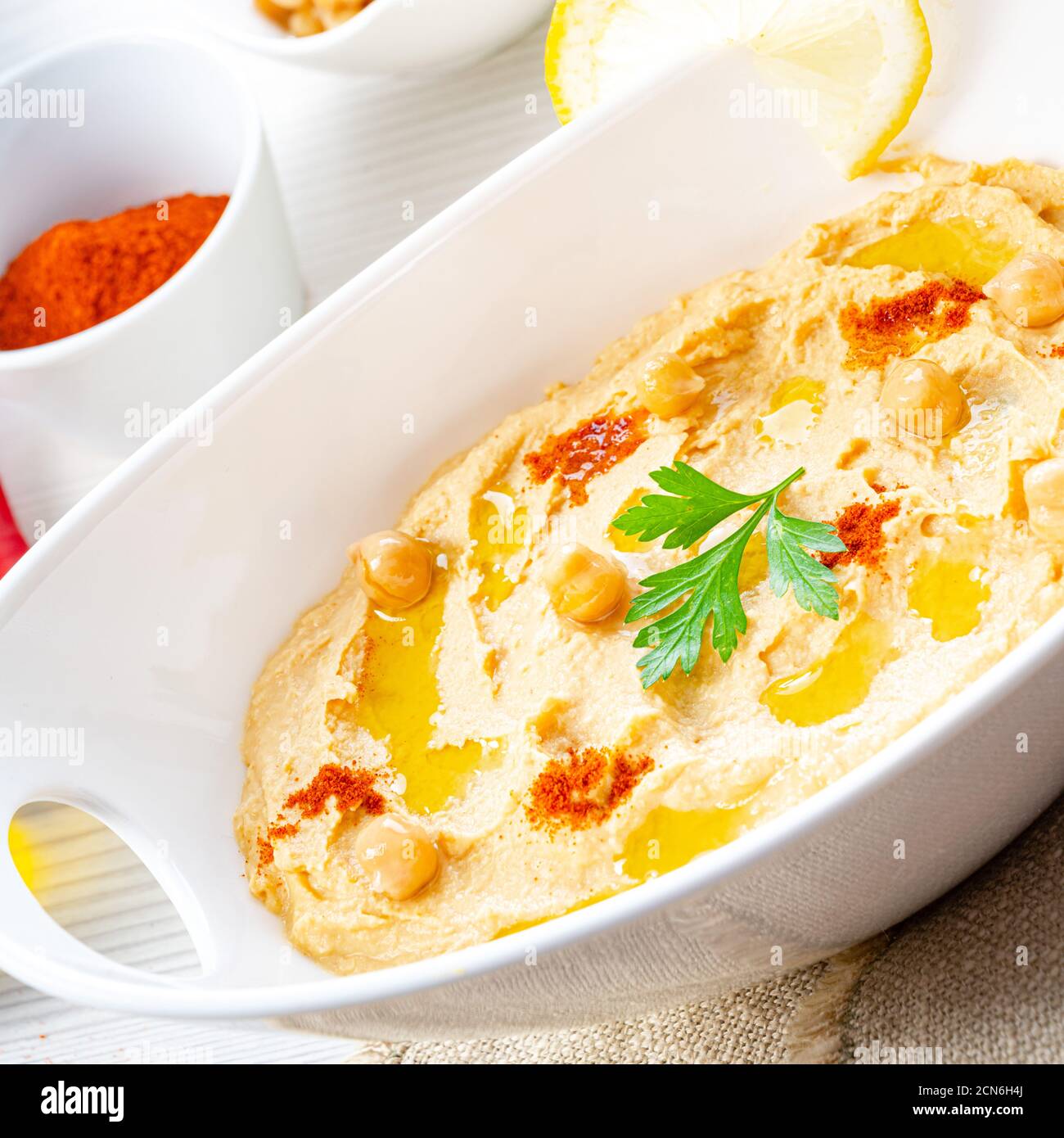 hummus paste with lemon and chilli on white background Stock Photo - Alamy