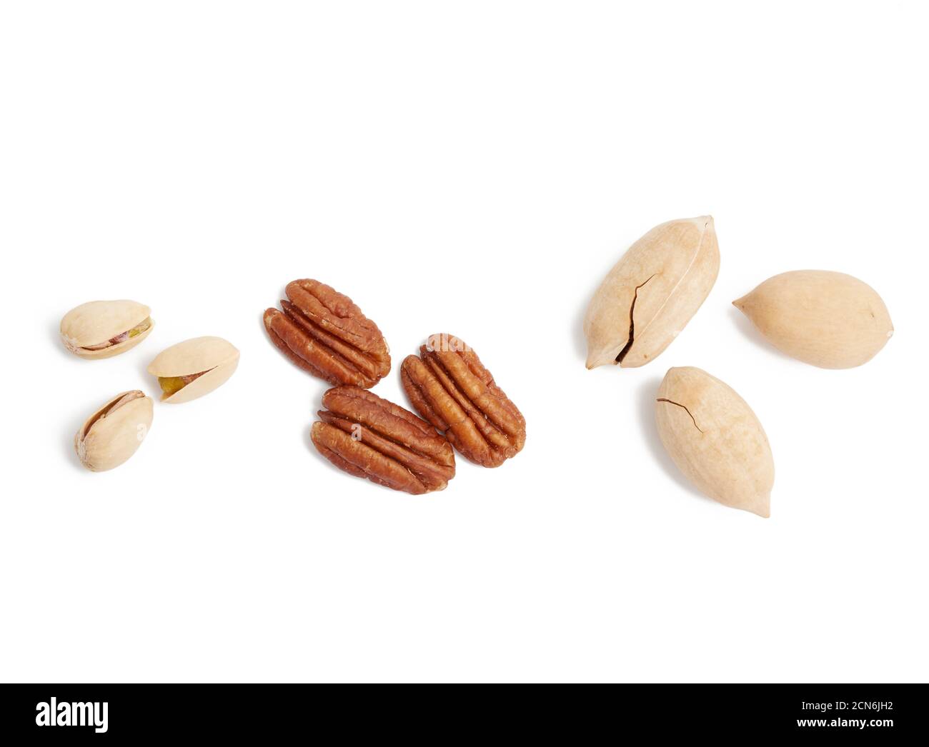 heaps of peeled and unpeeled pecans on a white background Stock Photo ...