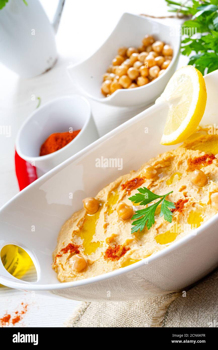 hummus paste with lemon and chilli on white background Stock Photo - Alamy