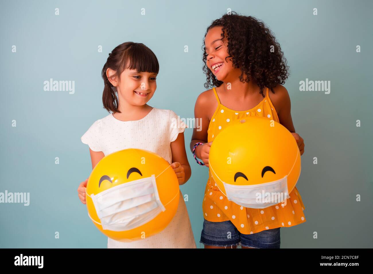 Two Kids Playing With Face Covering Mask Toys Stock Photo - Alamy