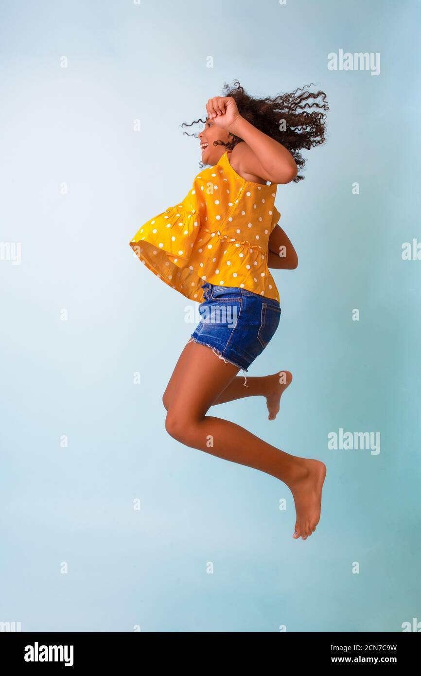 African American Girl Jumping With Happiness Stock Photo - Alamy
