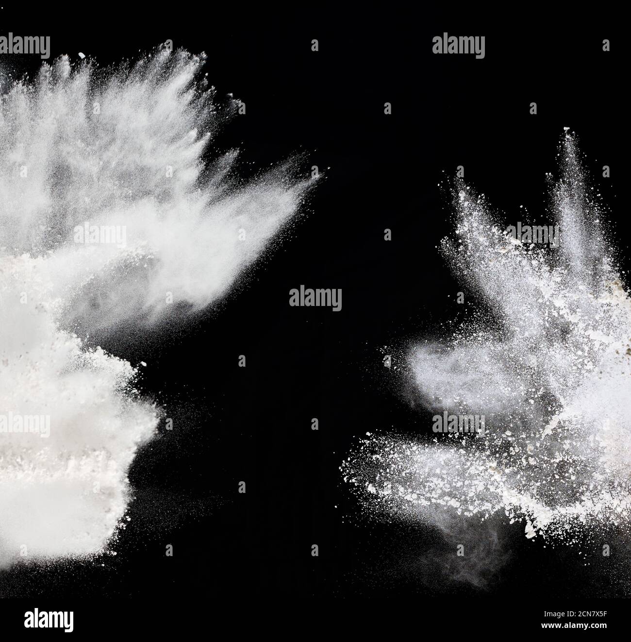 cloud of white wheat flour on a black background, particles fly in ...