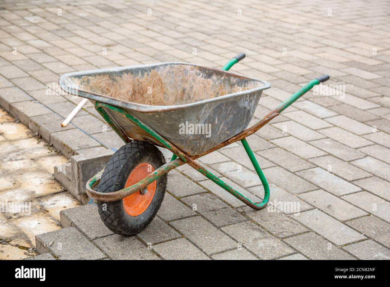 Old gray household wheel barrow Stock Photo - Alamy
