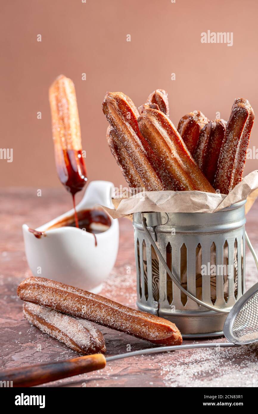 Traditional churros sticks with cinnamon and chocolate Stock Photo - Alamy