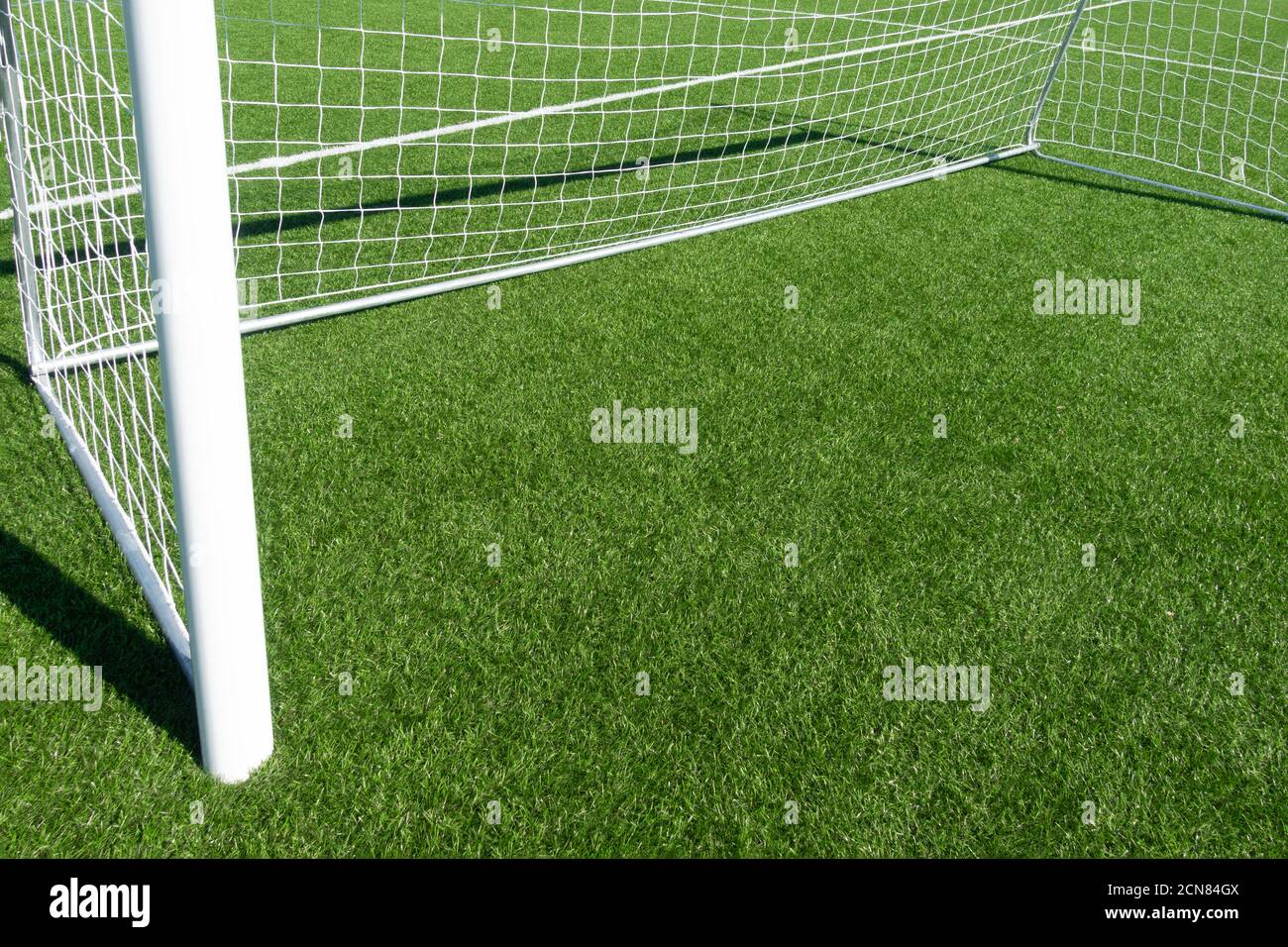 Close up of football soccer gate with white net and green grass ...