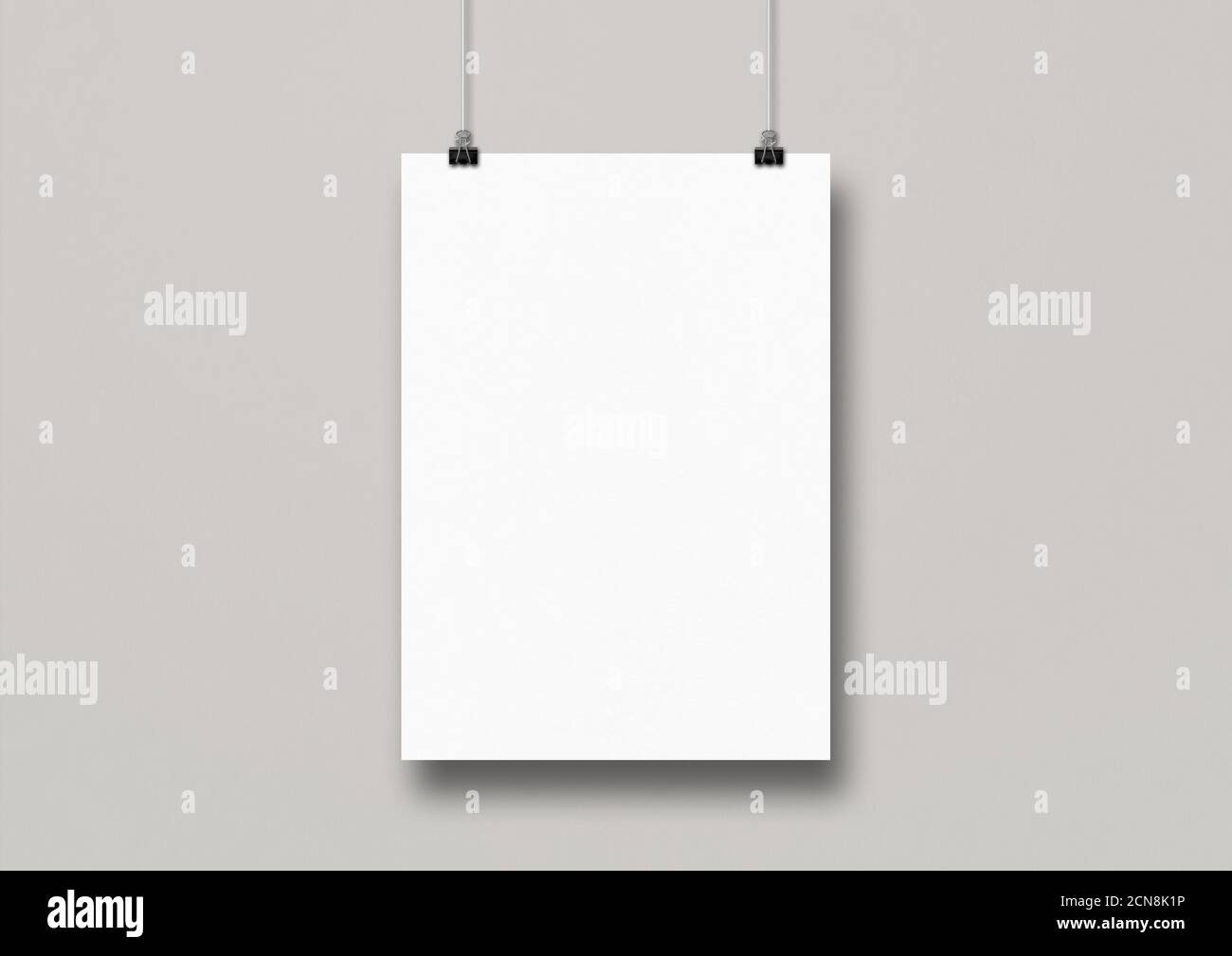 White poster hanging on a clean wall with clips Stock Photo - Alamy