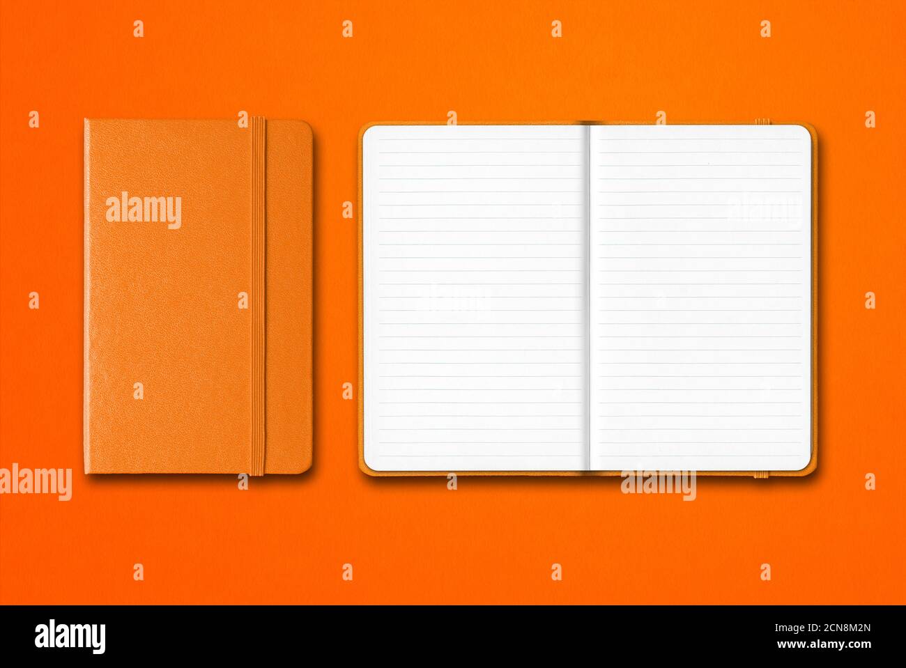 Orange closed and open lined notebooks isolated on colorful background ...