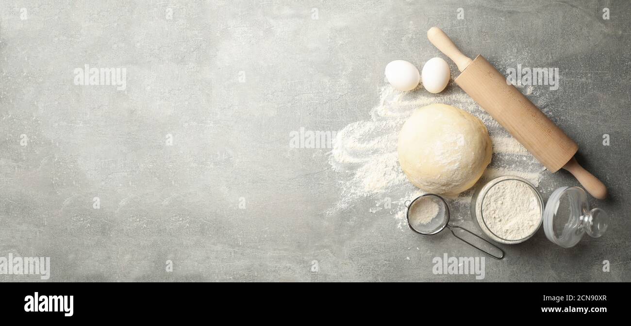 Concept for baking with dough on gray background Stock Photo - Alamy